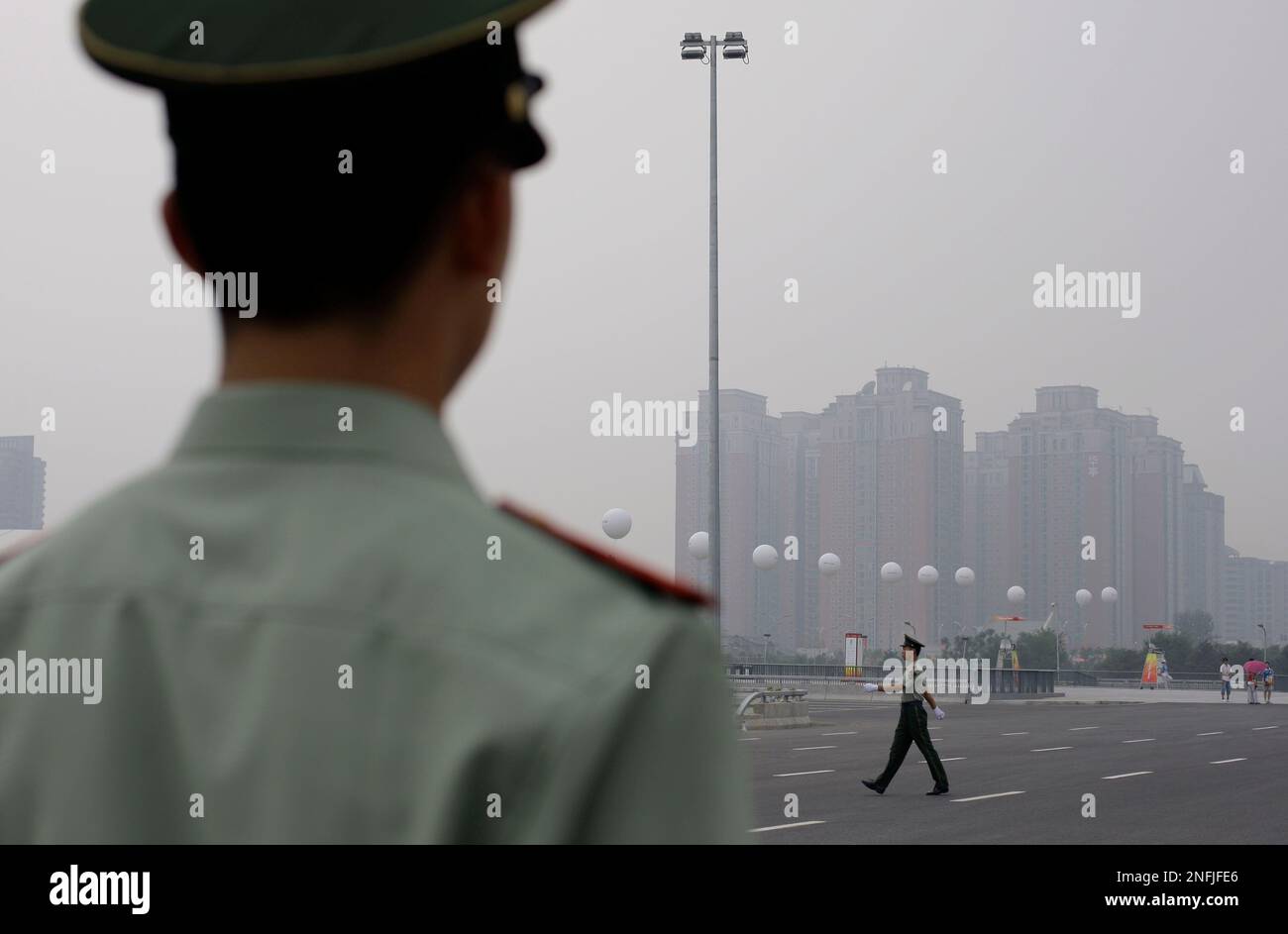 Chinese paramilitary police officers patrol in the Olympic green , a ...