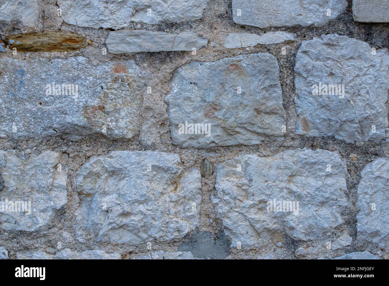 This close-up photo of a brick wall captures the rugged texture and ...