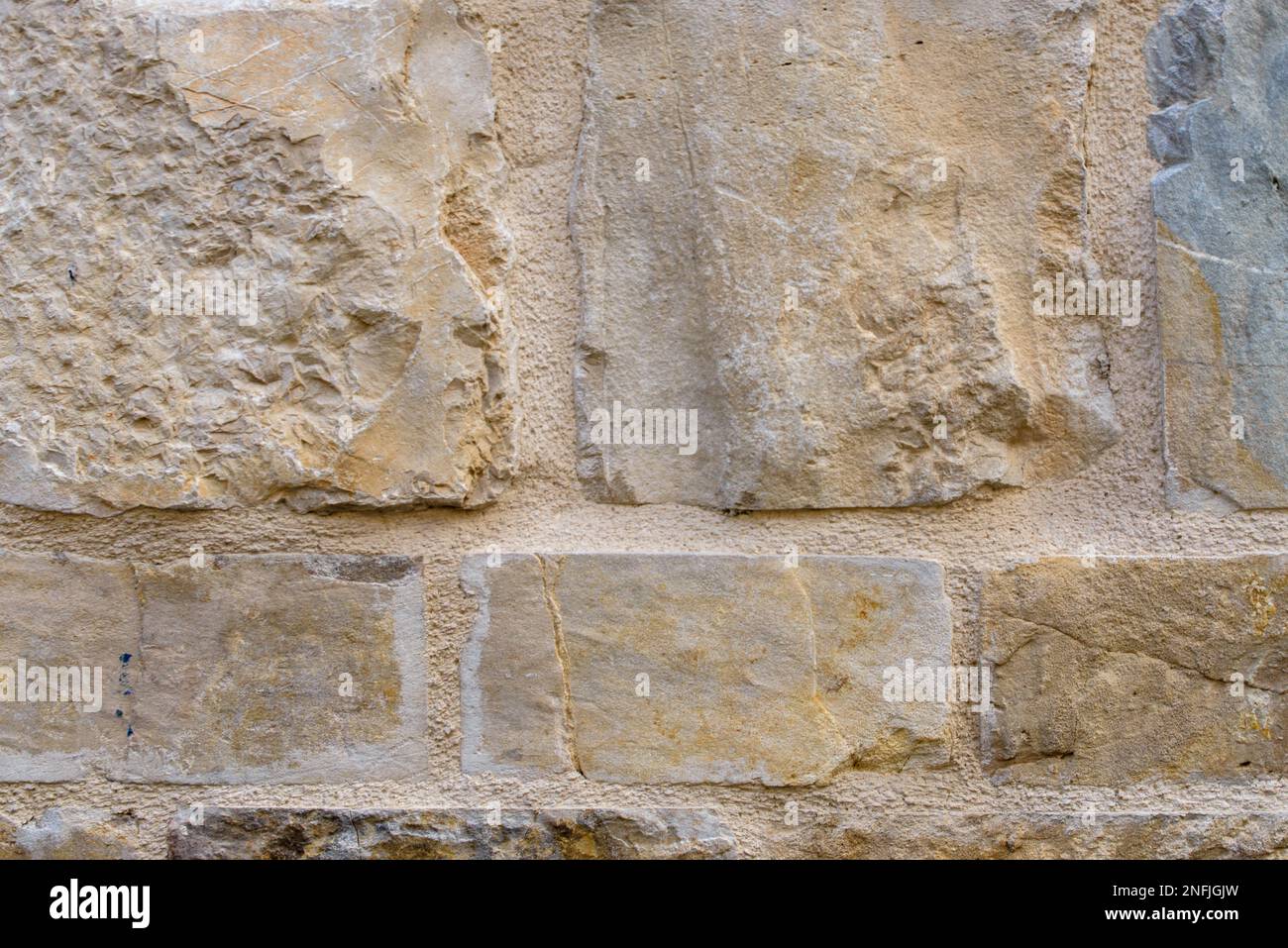 This close-up photo of a brick wall captures the rugged texture and ...