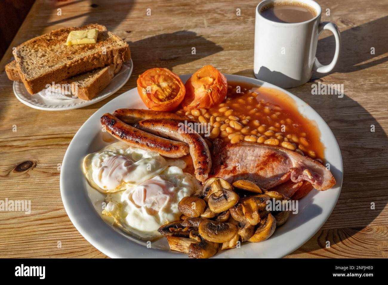 Traditional Full English Breakfast with Eggs, Bacon, Sausage, and Baked ...