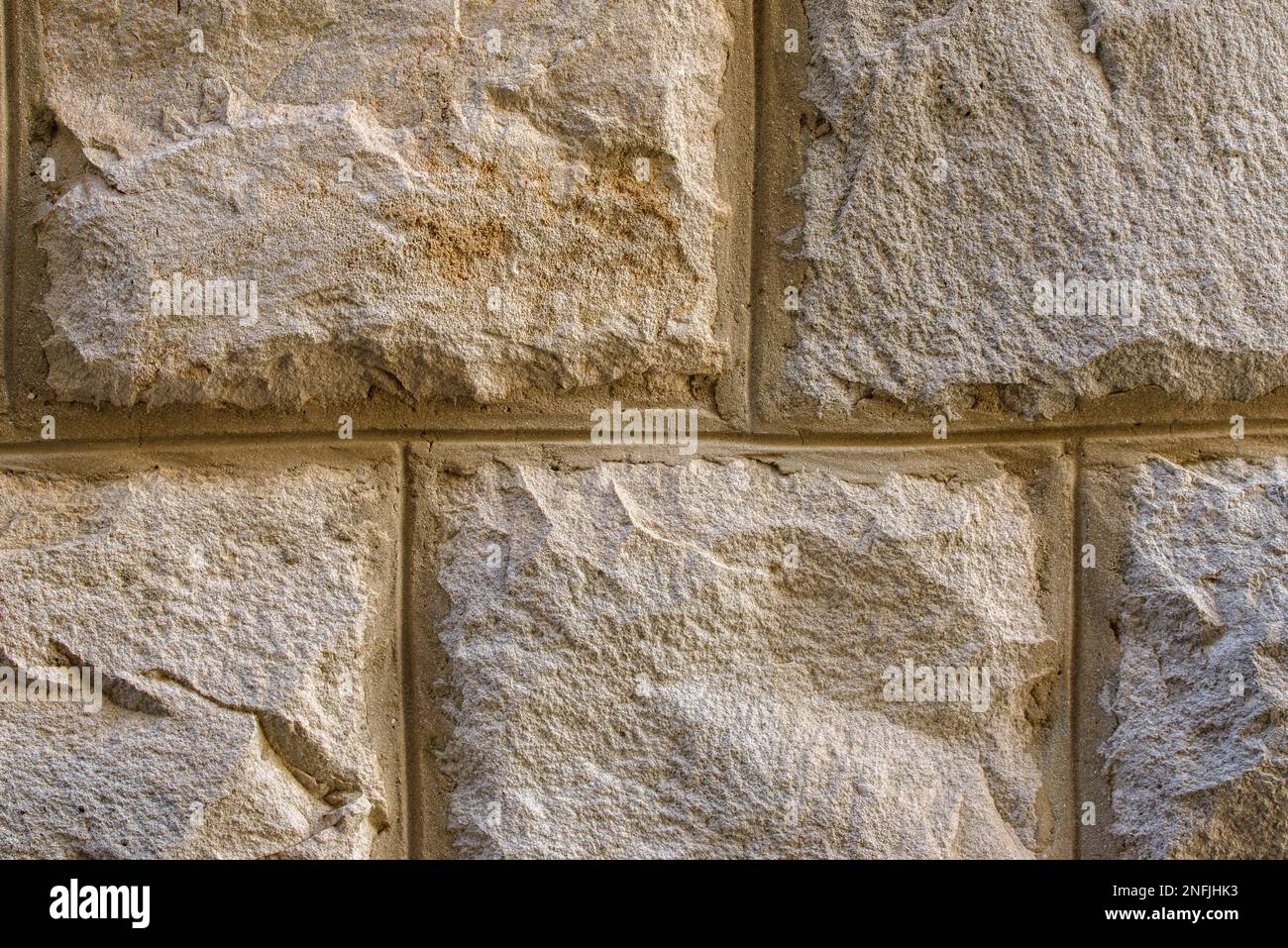 This close-up photo of a brick wall captures the rugged texture and ...