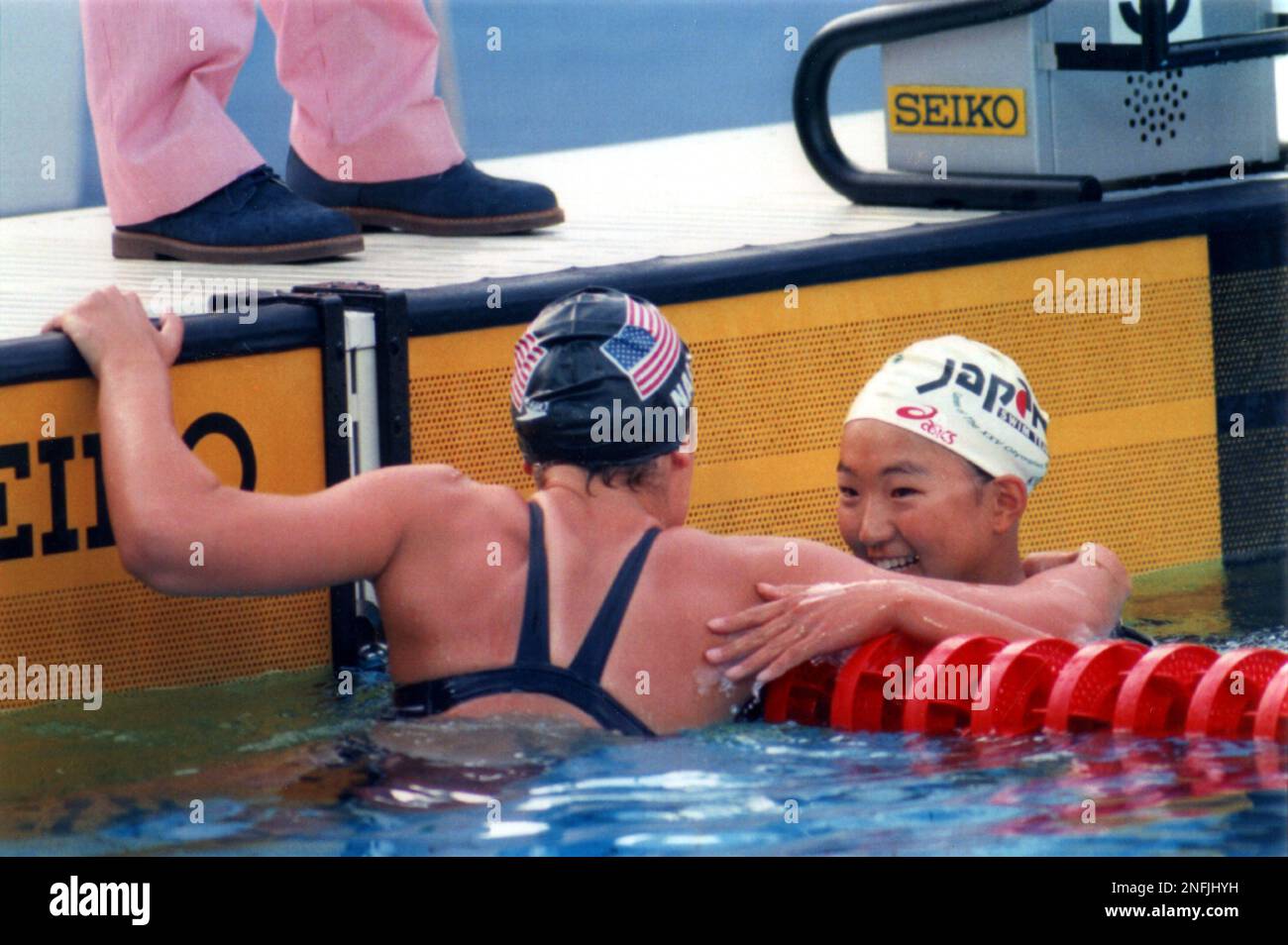 Japan's Kyoko Iwasaki, right, is embraced by Anita Nall after taking ...