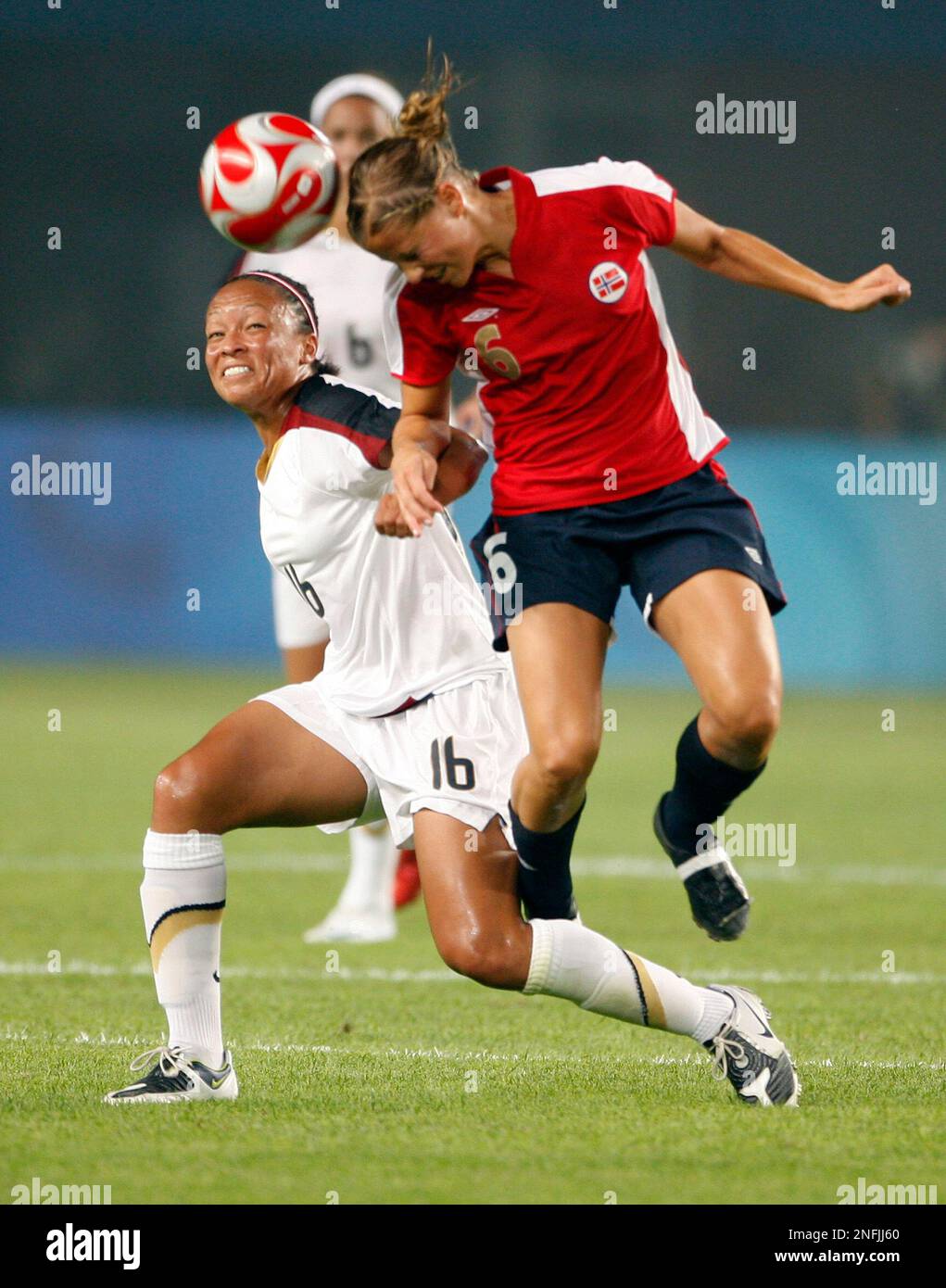 Angela Hucles from the US, left, battles for the ball with Marie ...