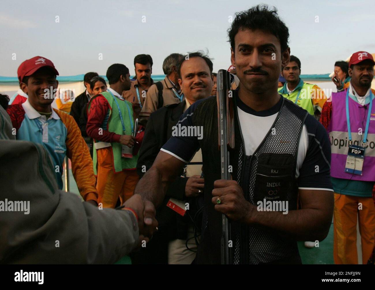 ** FILE **India's Rajyavardhan Singh Rathore is congratulated after ...