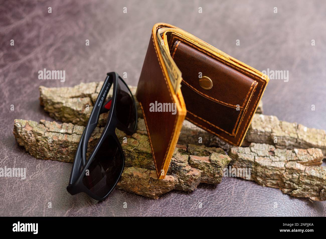 Open brown mens wallet with money and credit cards on leather ...