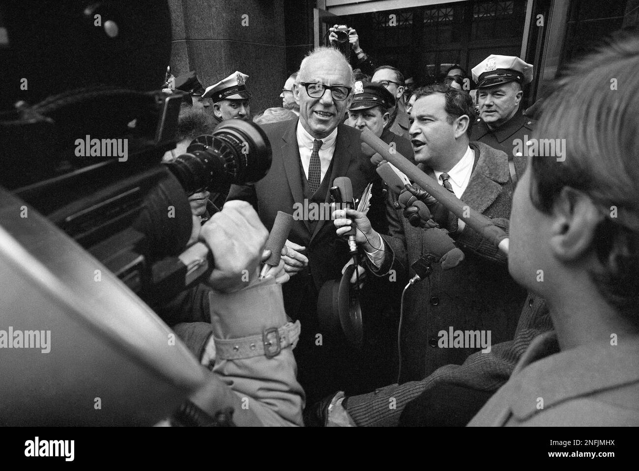 Dr. Benjamin Spock talks with newsmen outside Federal Building in ...