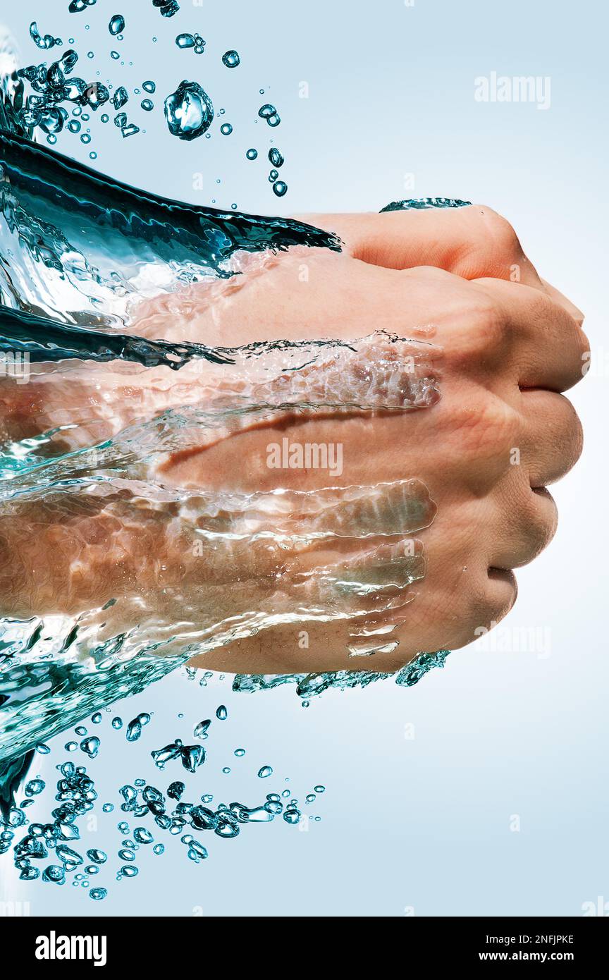 Man hand fist hits the water on light blue gradient background Stock ...