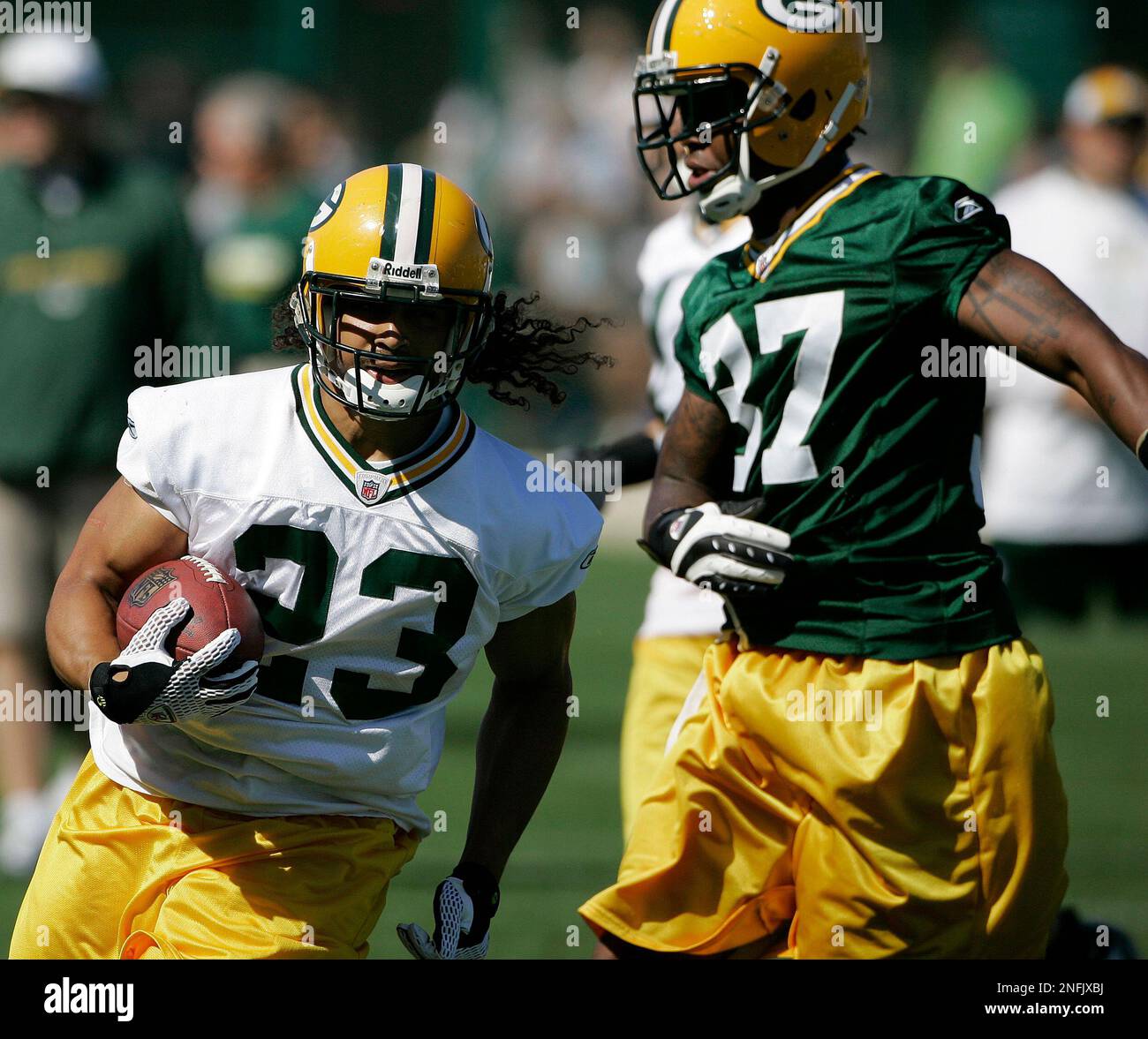 Green Bay Packers' Noah Herron runs past Aaron Rouse (37) at football ...