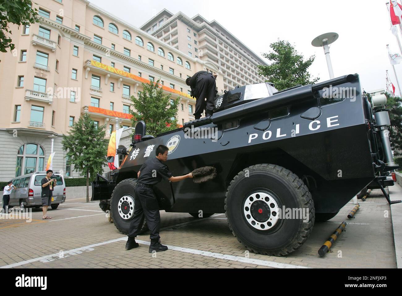 Members of a Chinese police SWAT team clean their armored vehicle ...