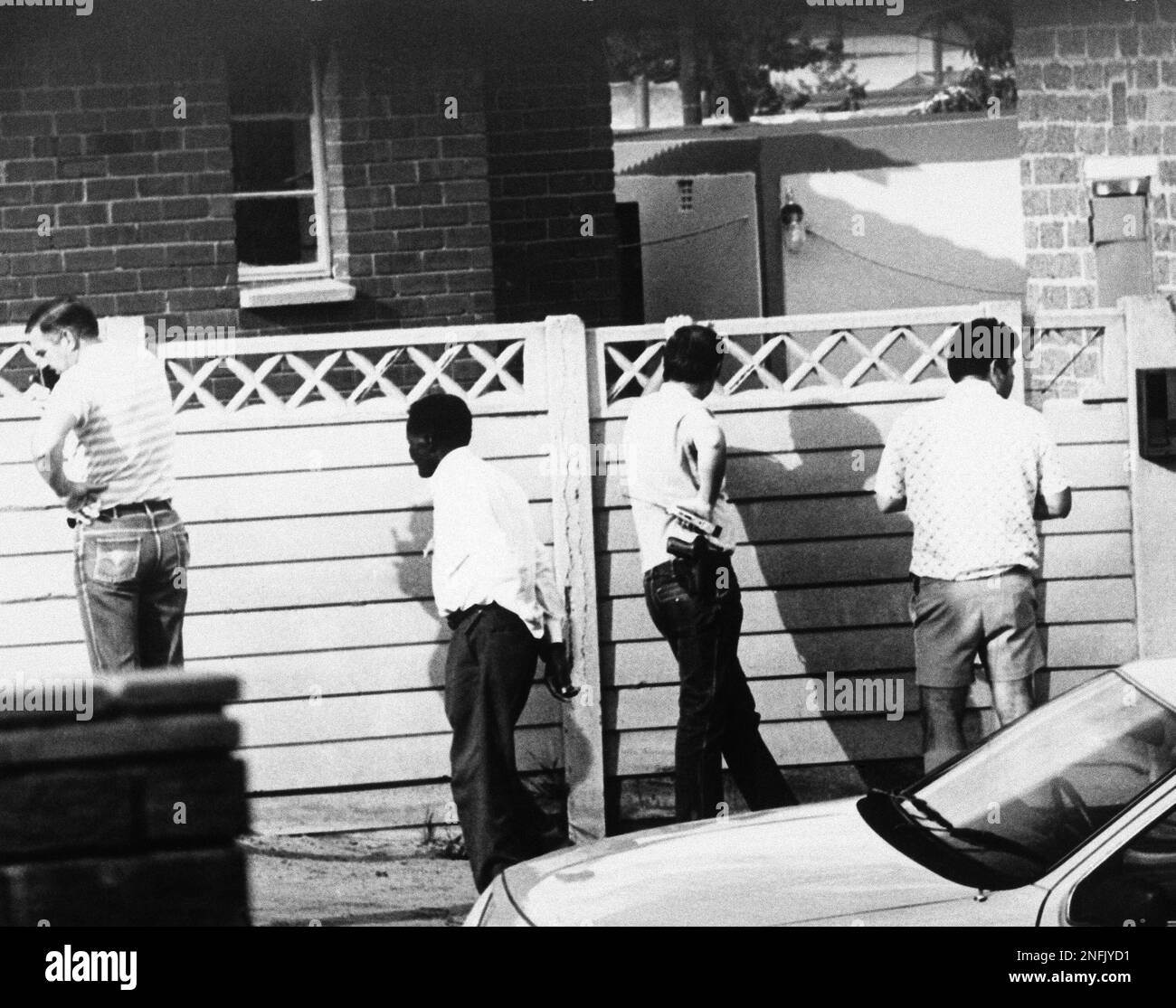 Plain-clothes policemen stand outside the home of black activist Winnie ...