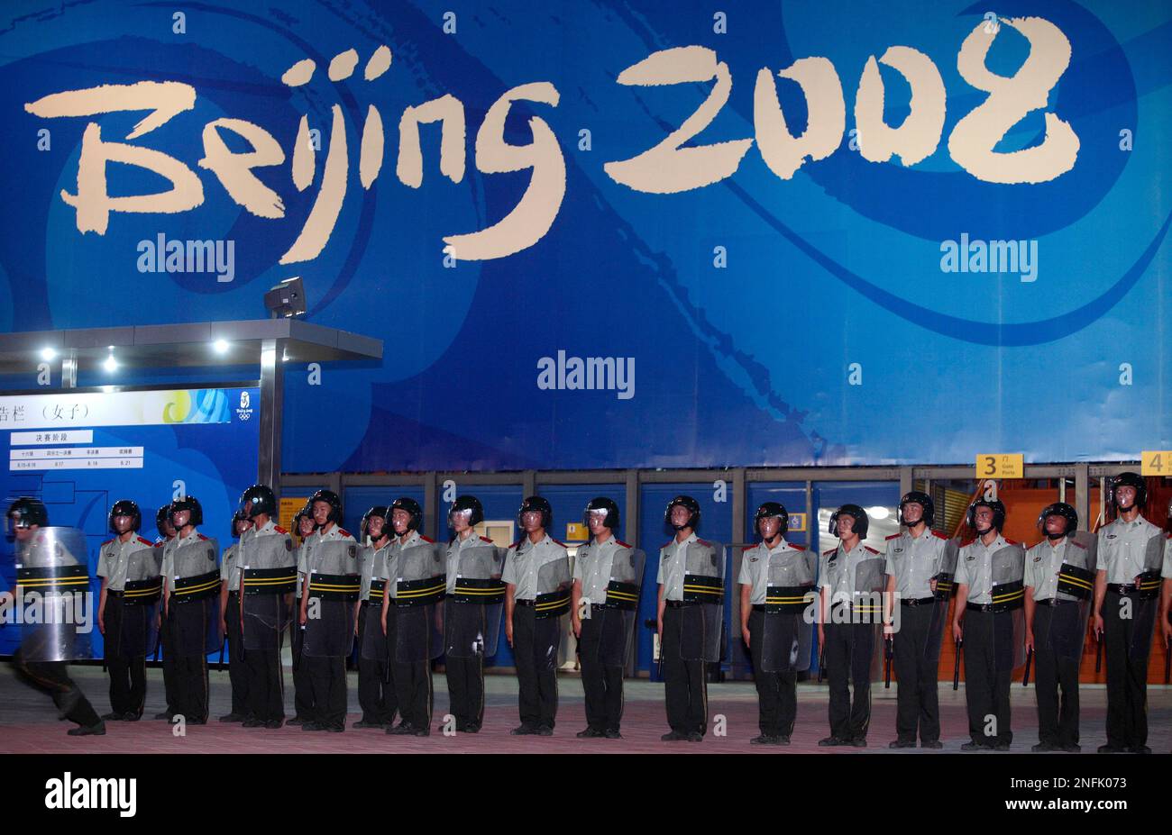 Chinese paramilitary police officers in anti-riot gear take part in a ...