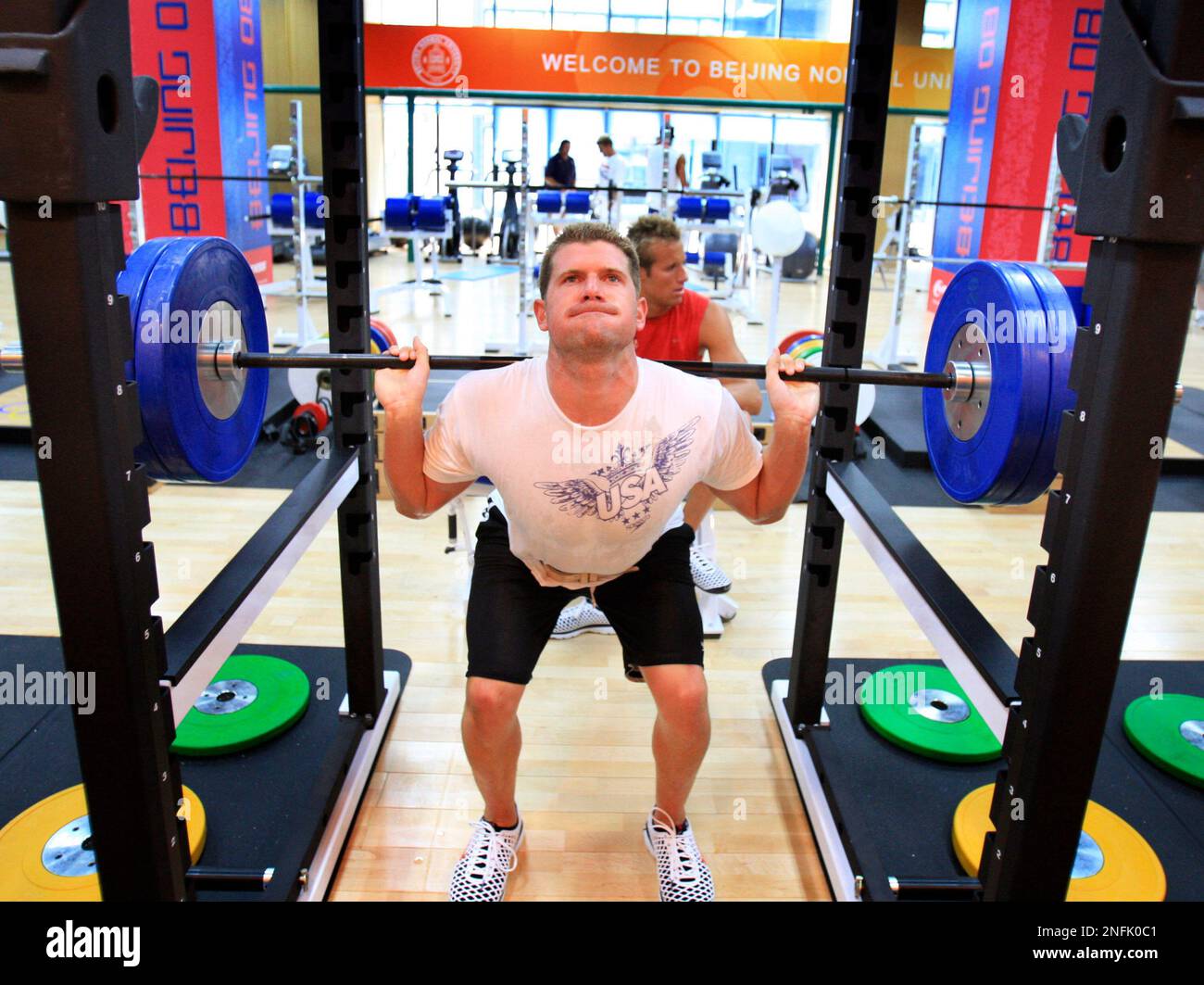 U.S. Olympic water polo player Rick Merlo lifts weights while working ...