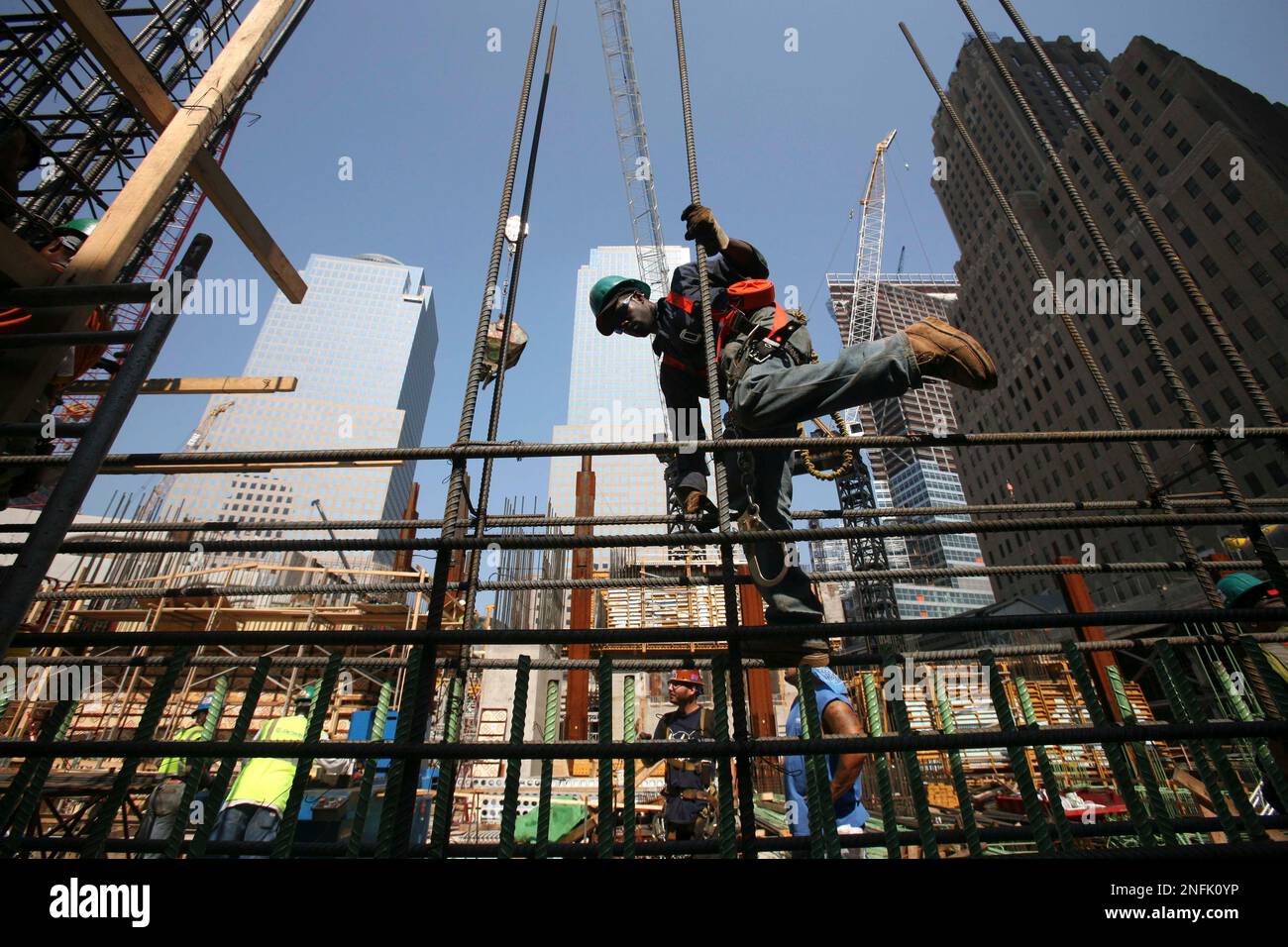 Ironworker Donald Sibbles works on a concrete and steel wall adjacent ...