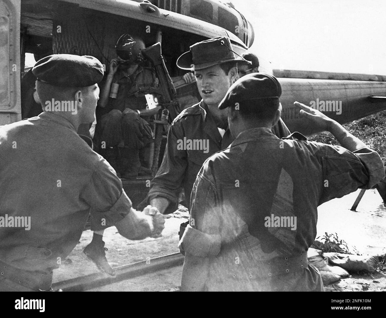 Sen. Edward Kennedy, center, is welcomed to Cai Cai Special Forces Camp ...