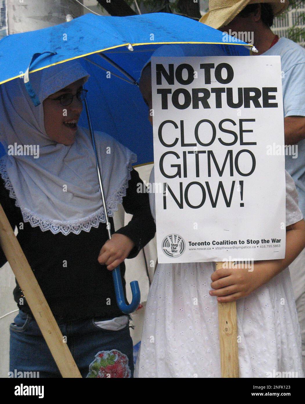 Two girls attend a rally in Toronto on Saturday, July 26, 2008 to press ...