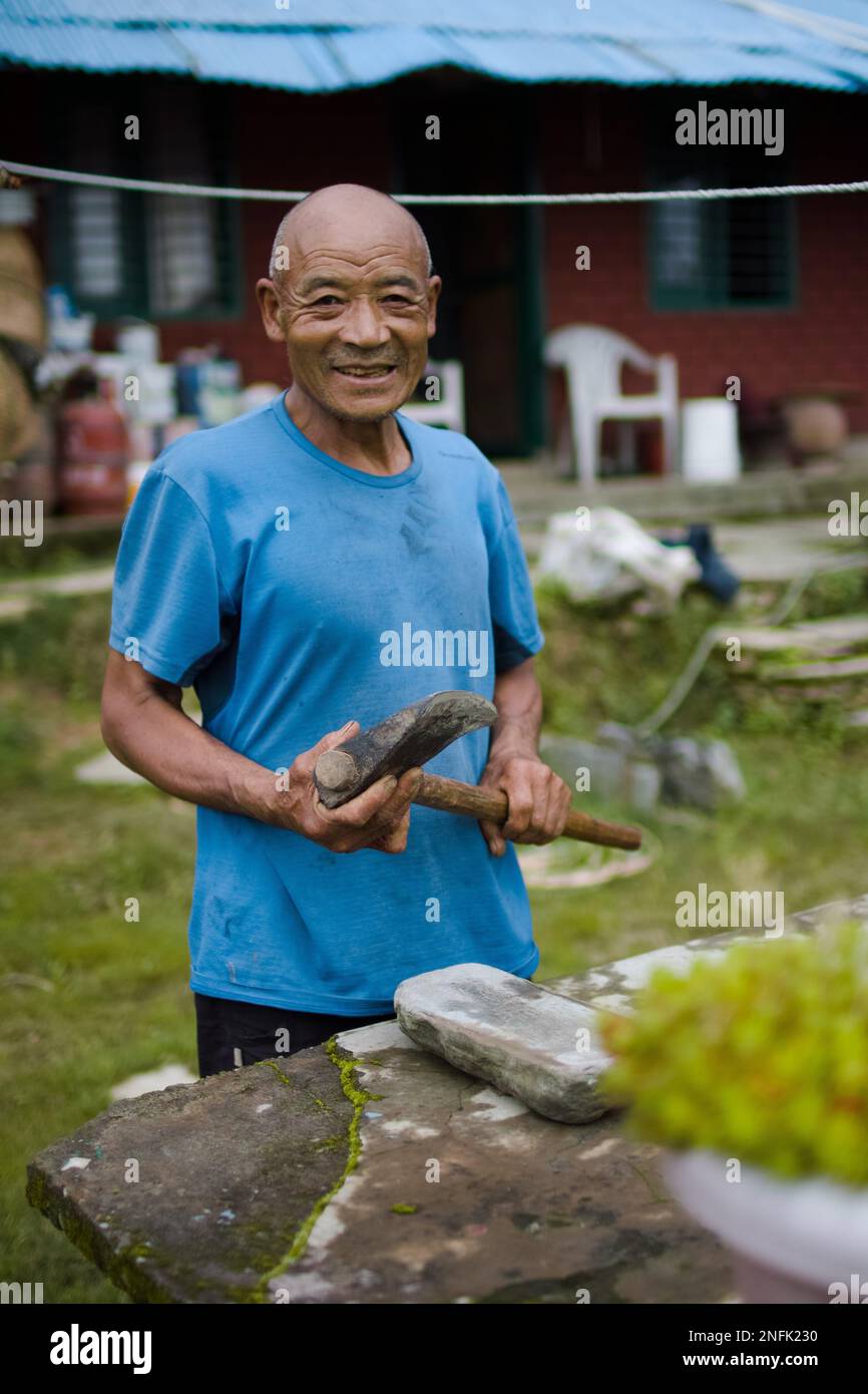 Nepal man sharpening tool Stock Photo - Alamy