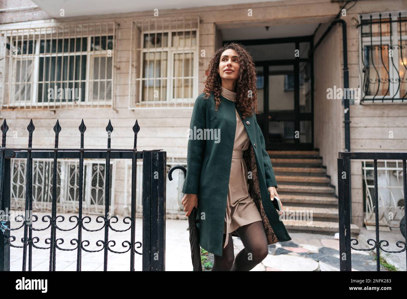 Beautiful young girl model posing near the house Stock Photo - Alamy