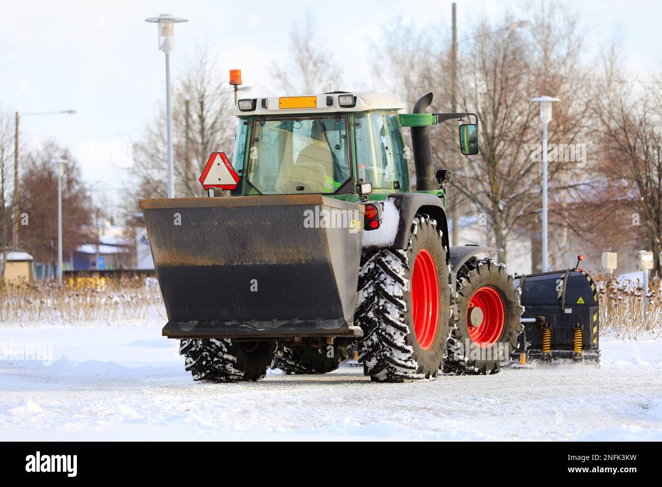 Tractor spreading grit with ATI 18 gritter and ploughing snow off ...