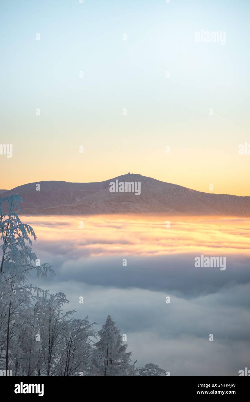 Fabulous winter scenery with a view of the sea of clouds illuminated by ...