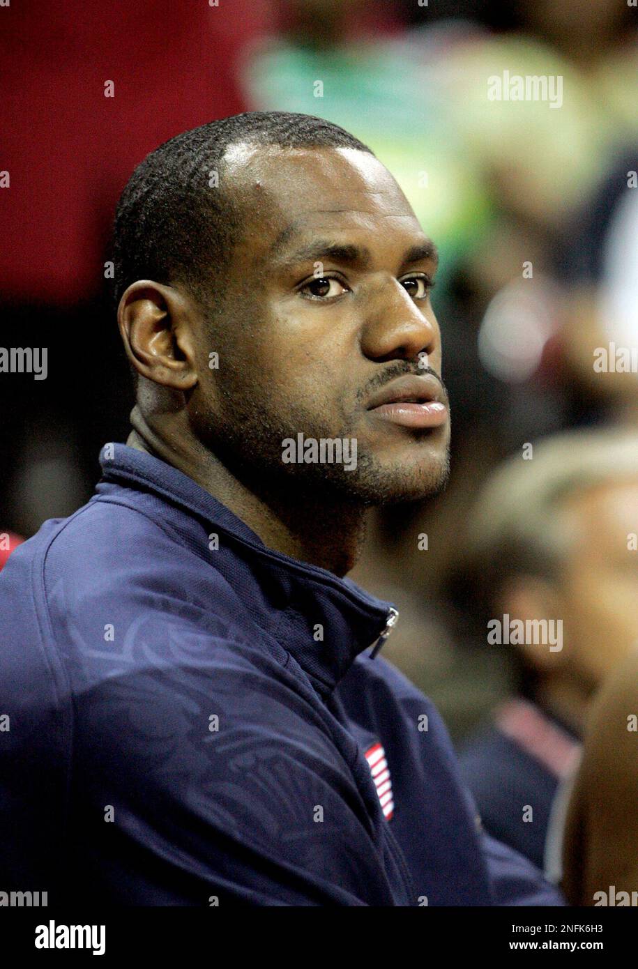 Injured U.S. forward LeBron James sits on the bench during an ...
