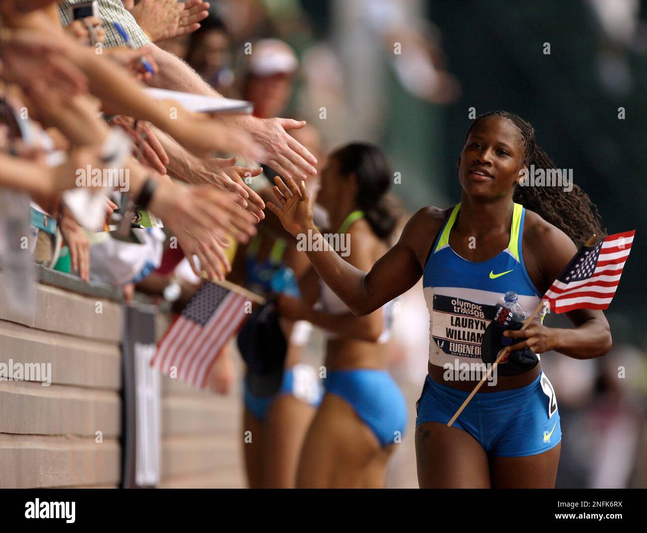 Lauryn Williams is congratulated by fans after finishing third in the ...
