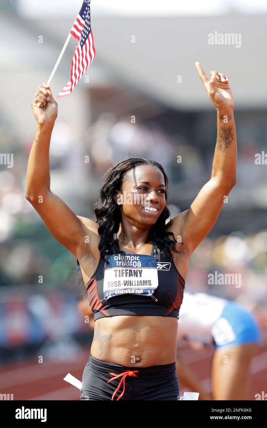 Tiffany Ross-Williams waves an American flag after crossing the finish ...