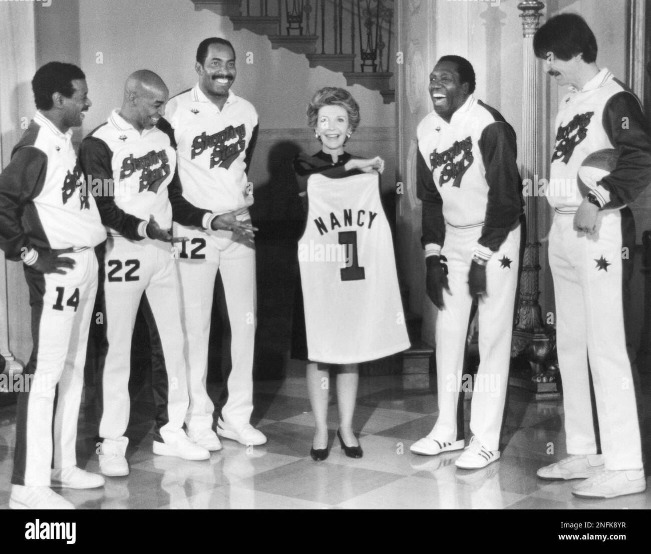 First Lady Nancy Reagan receives a basketball jersey presented to her ...
