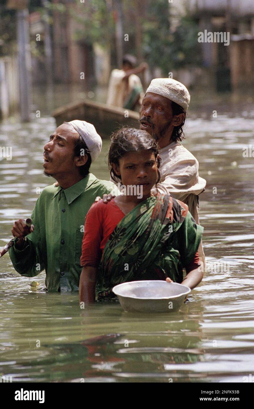 Three beggars, two of whom are blind, take to the flooded streets to ...