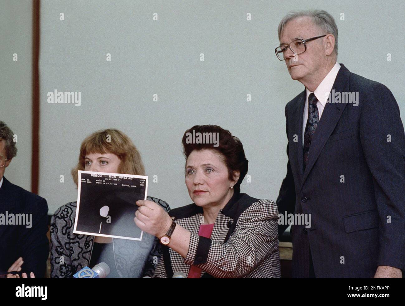 Retired Soviet Air Force Colonel Marina Popovich, center, shows a photo, taken from a Soviet ...