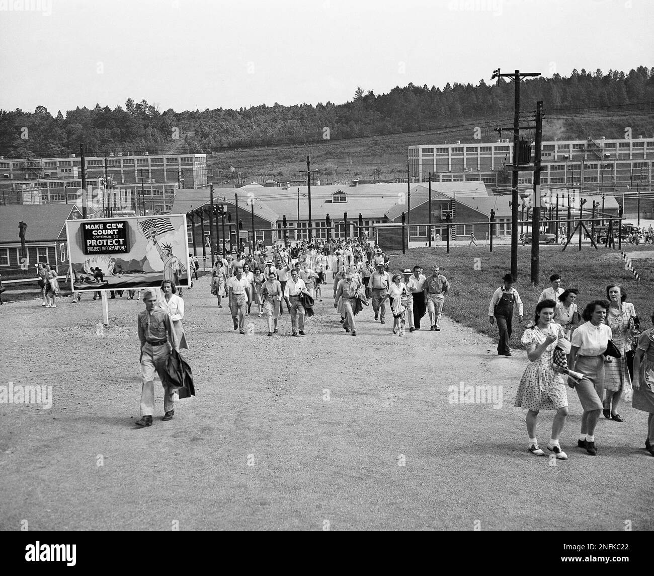Workers leave the atomic bomb production plant during the 3pm shift ...