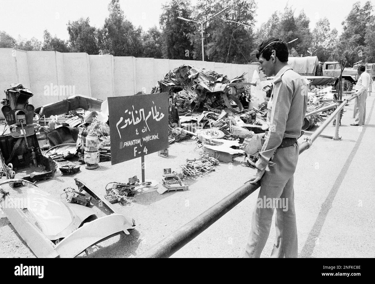 An Iraqi soldier views the wreckage of an Iranian Phantom F4, downed by ...