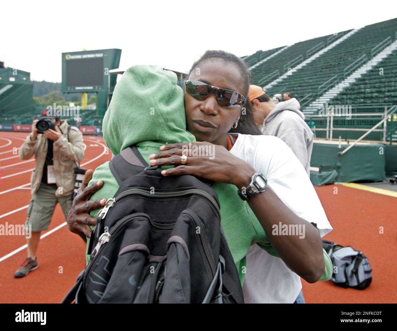 Mary Jane Reeves, back, hugs five-time Olympian Jearl Miles-Clark ...