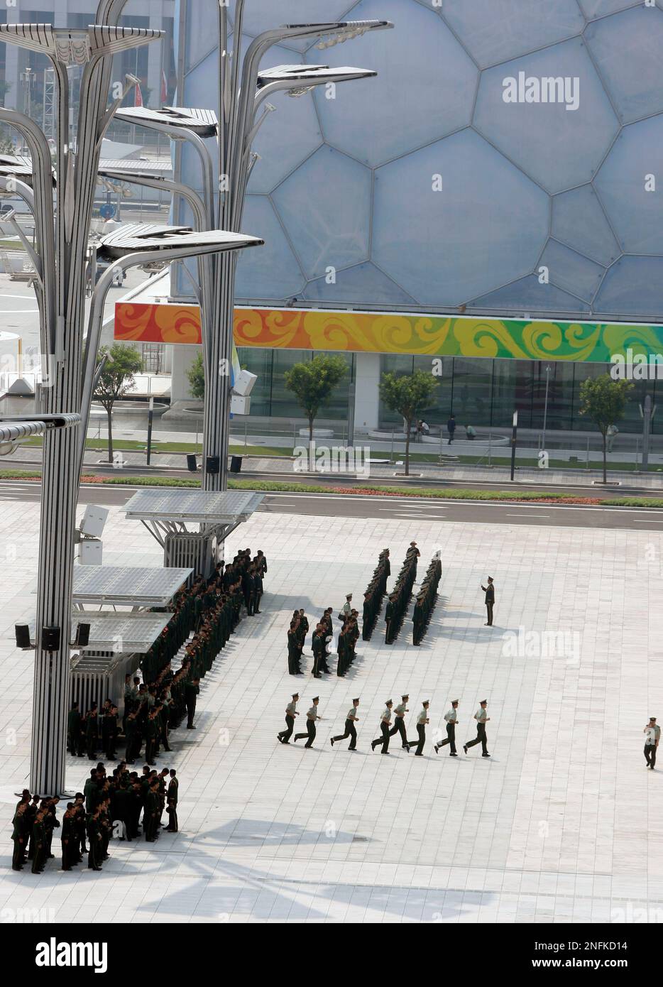 Chinese paramilitary soldiers rehearse an oath taking ceremony near the ...