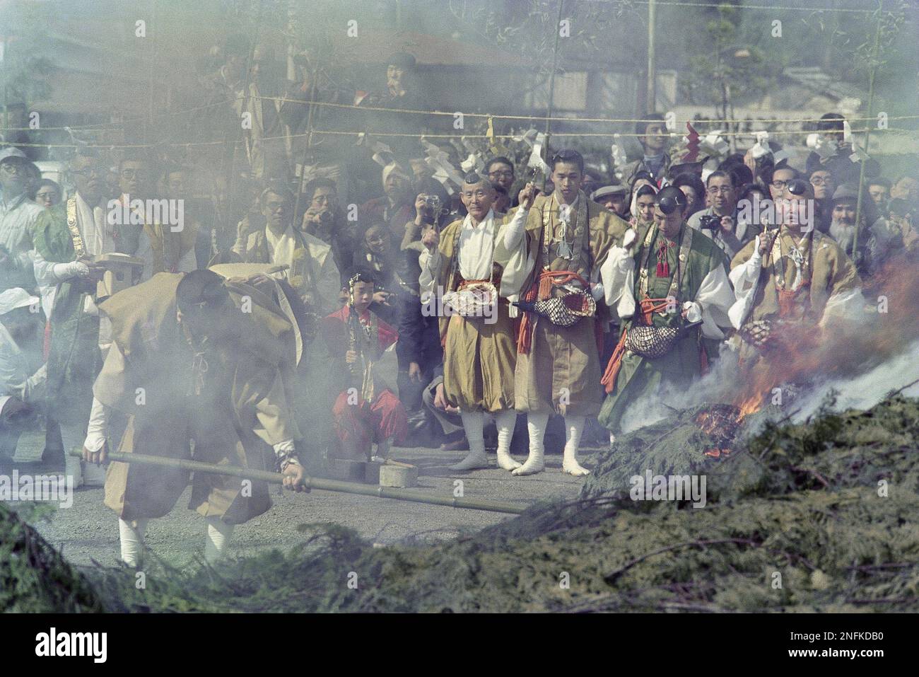 Smoke and flames come off the pyre of cedar branches as part of ...