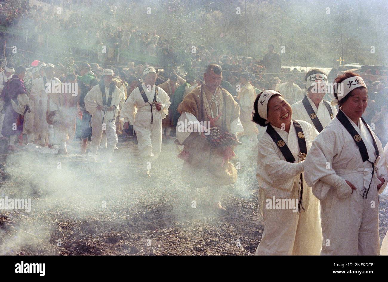 Believers, wearing white costumes believed to be sacred, follow a ...