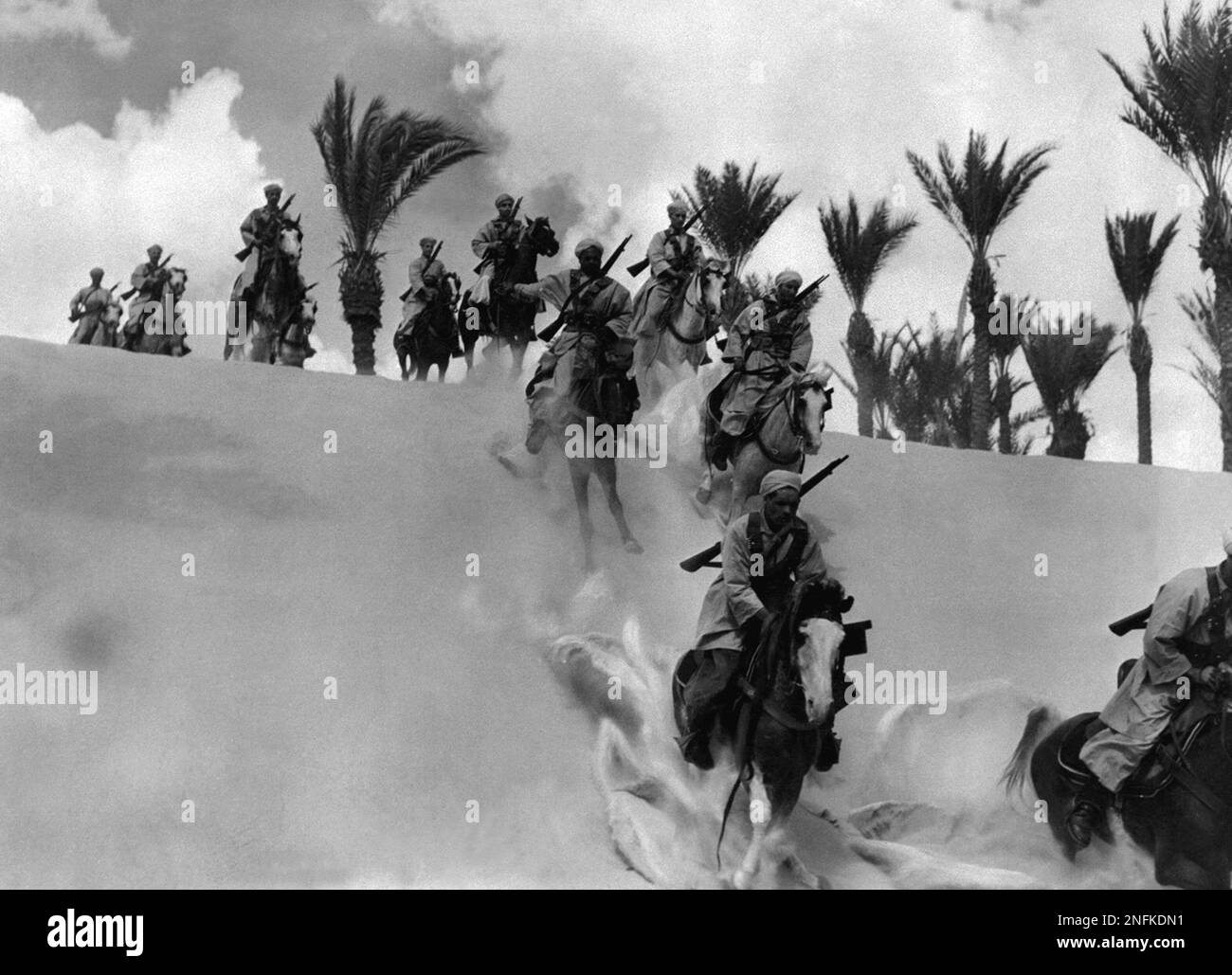 A patrol of Spahis, French Colonial Cavalry, gallop their mounts down ...
