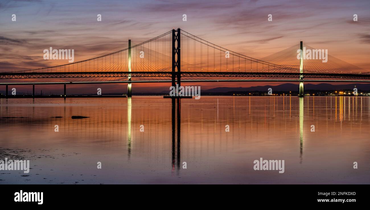 Panoramic view of Forth Road Bridge and Queensferry Crossing at sunset ...