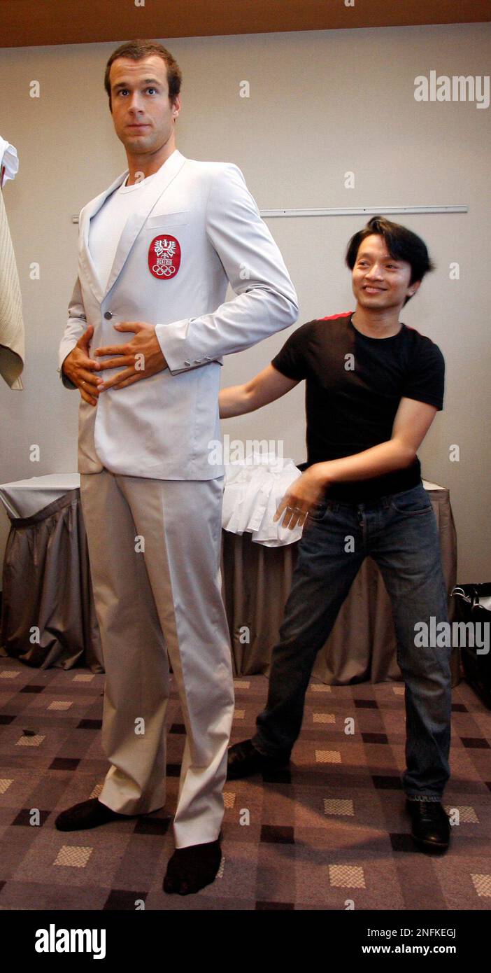 Austrian swimmer Markus Rogan, left, tries his new Olympic team uniform ...