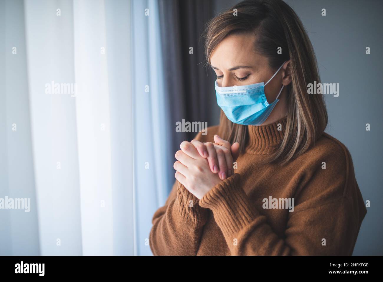 Woman praying on bed hi-res stock photography and images - Alamy