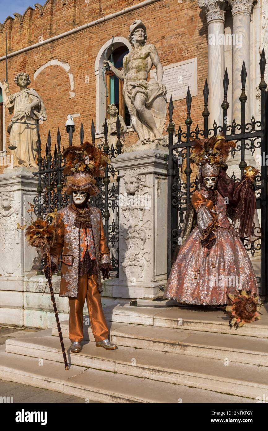 Carnival goers dressed in splendid costumes and masks during Venice ...