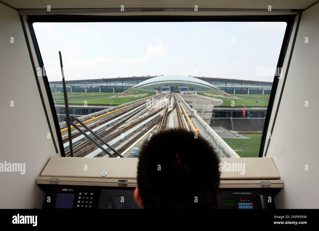 A train driver takes wheels in a cockpit of a subway train heading ...