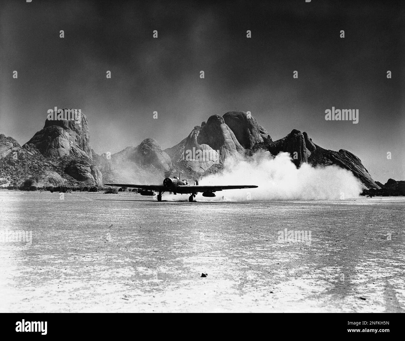 Against a background of rock formation a British bomber takes off here ...