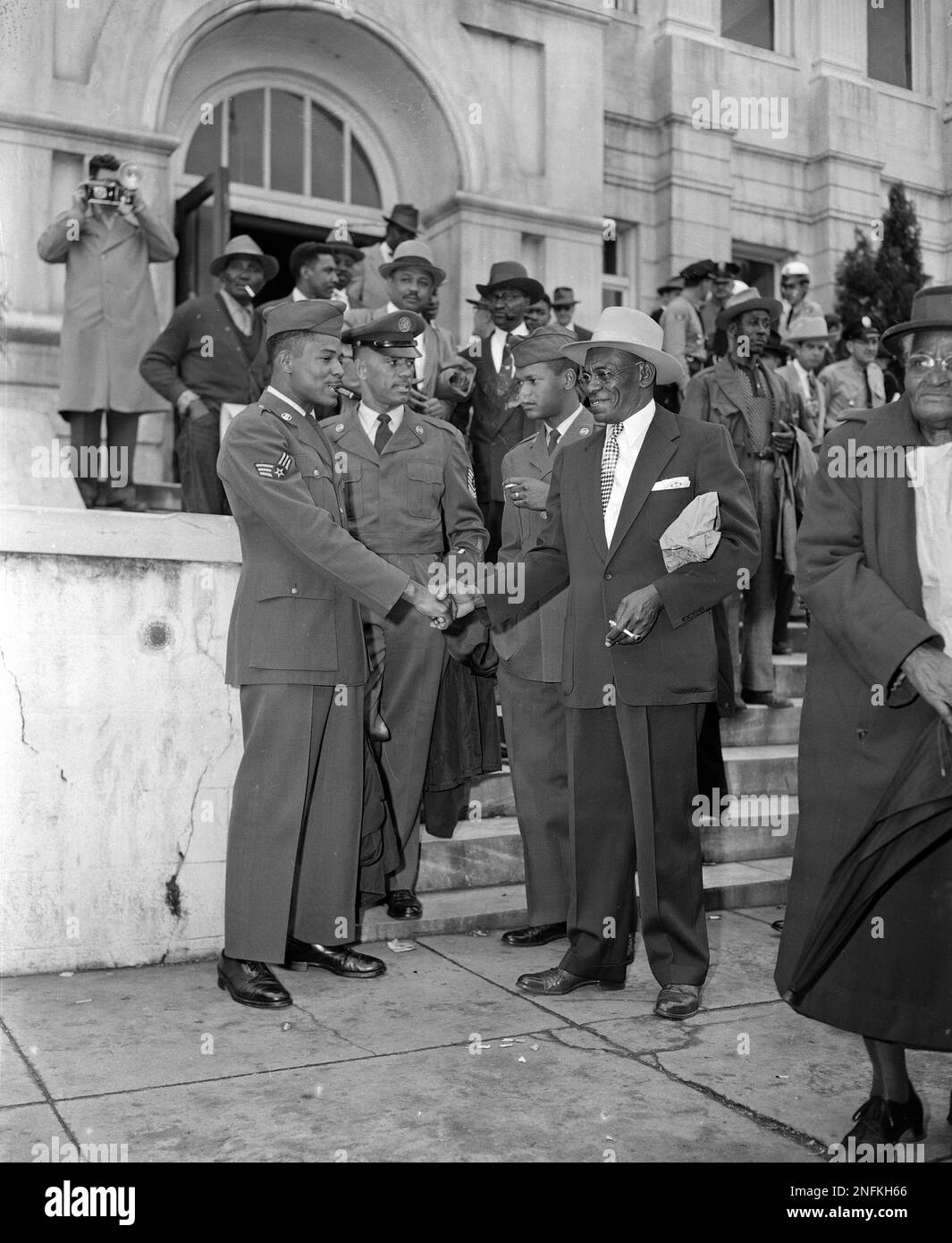 W.S. Tolbert, right, shakes hands with three Air Force men at ...