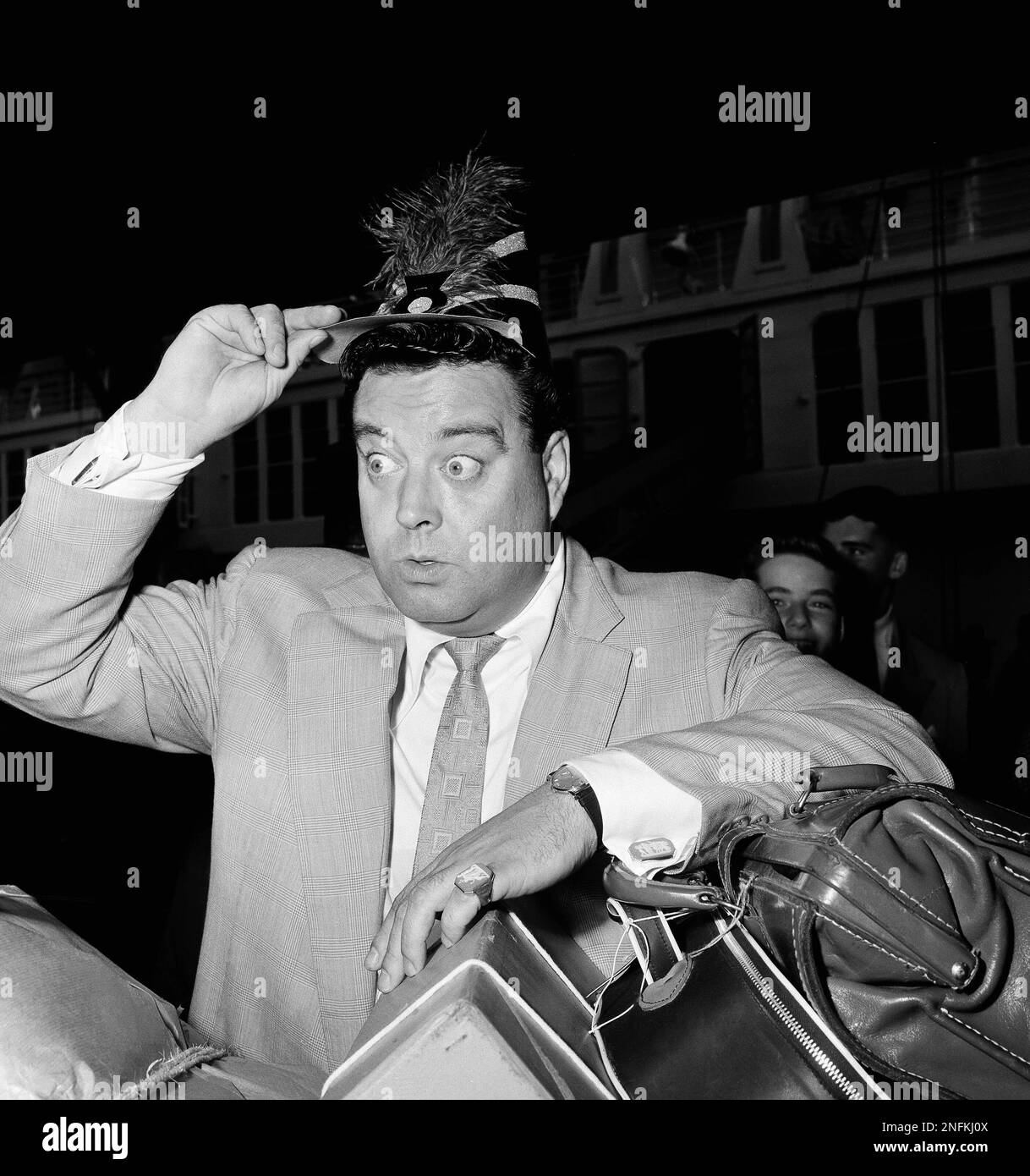 Television comedian Jackie Gleason dons a party hat as he awaits a ...