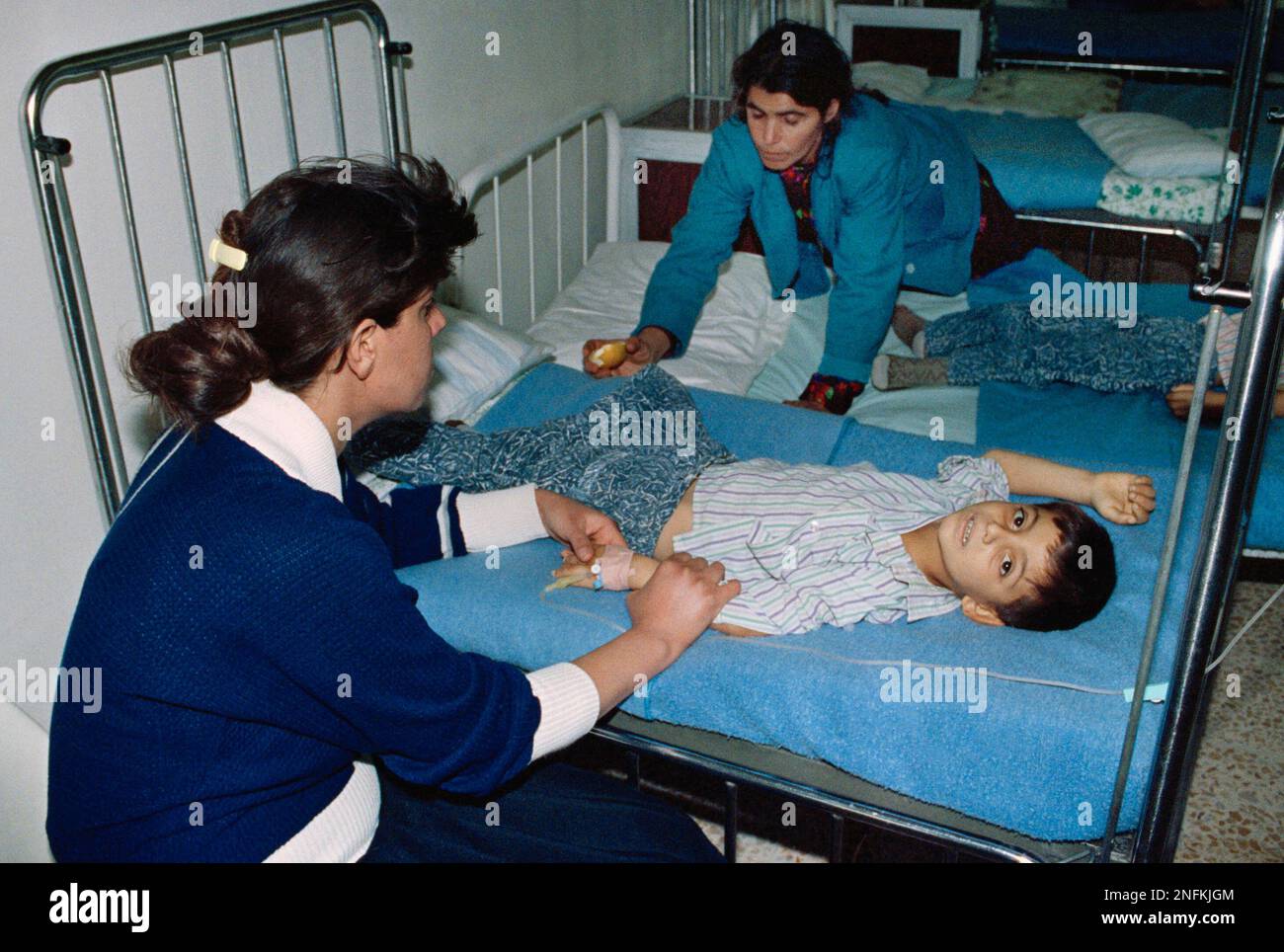 An Iraqi mother is pictured with her malnourished baby at a children's ...