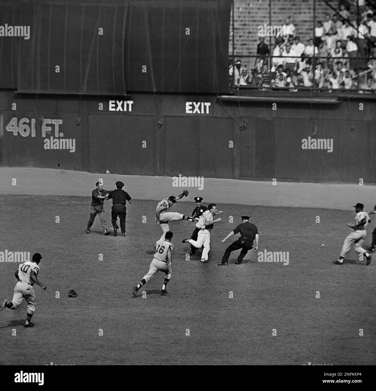 Jim Piersall of Cleveland, 37, kicks a fleeing Yankee fan, center ...
