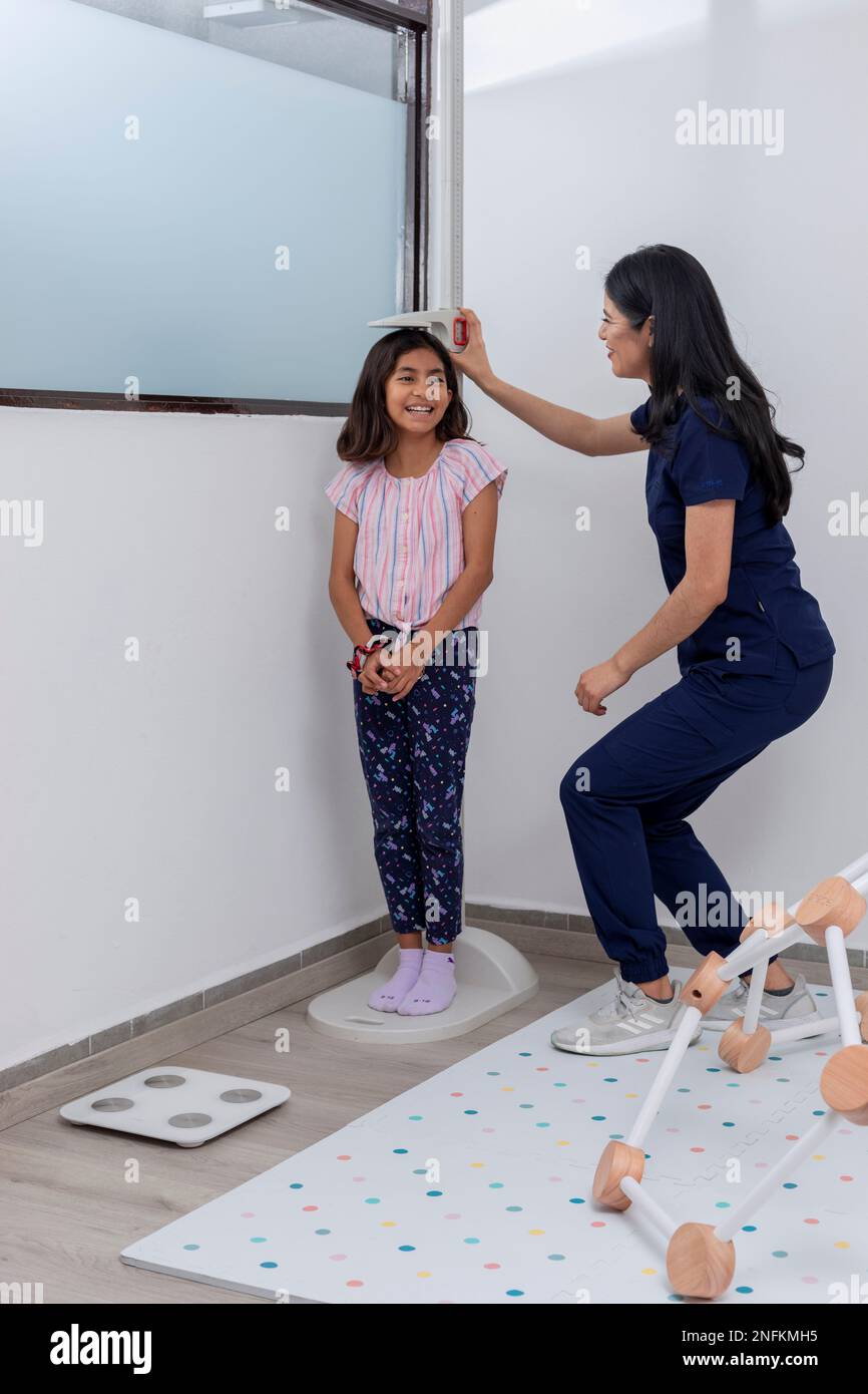 Paediatrician checking a child's height in her medical office Stock ...