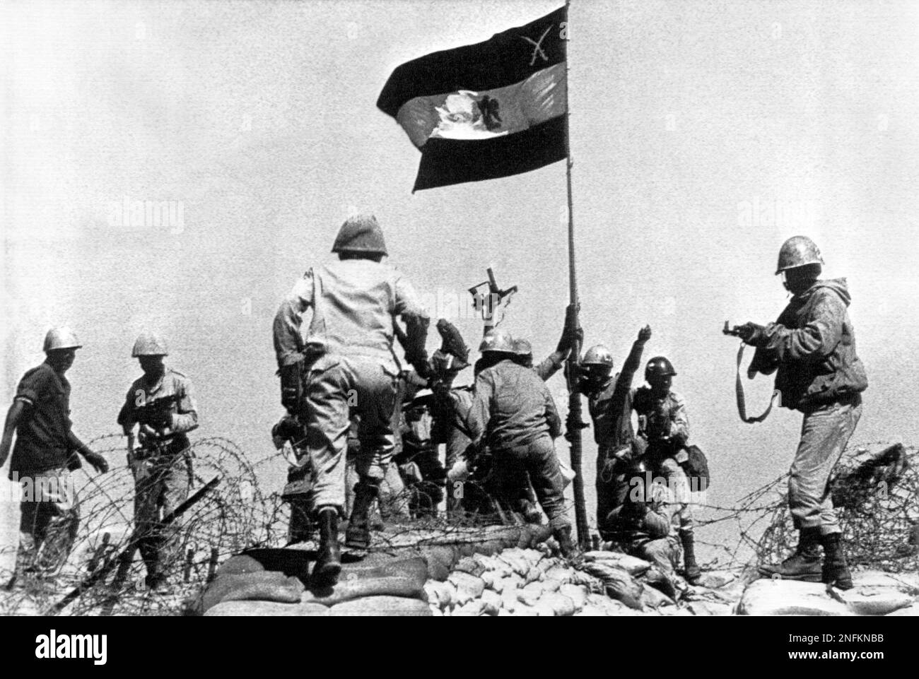 Egyptian troops jubilate as they plant their flag atop a bunker on Bar ...