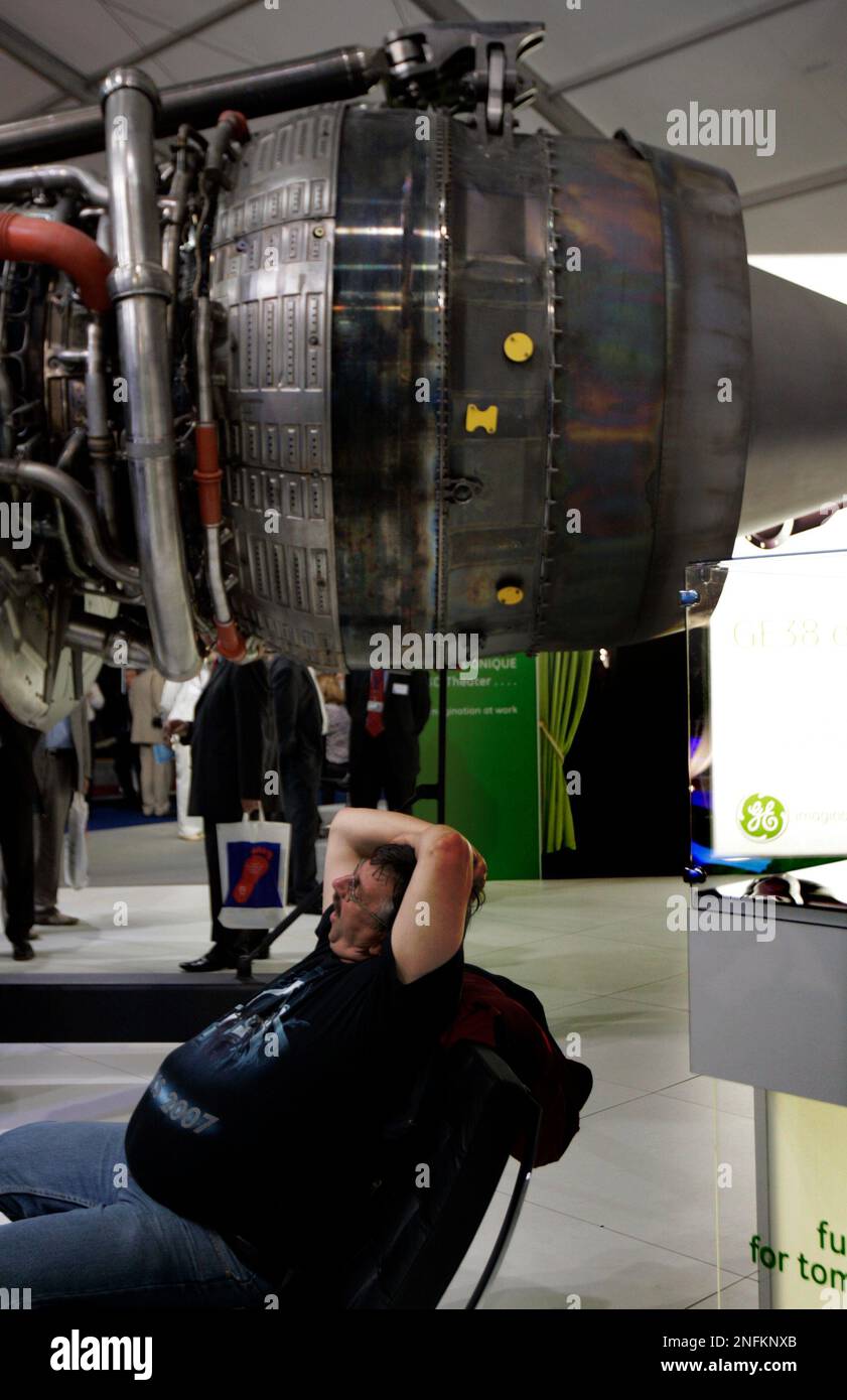 A visitor takes some rest, backdropped by part of a life-size model of ...