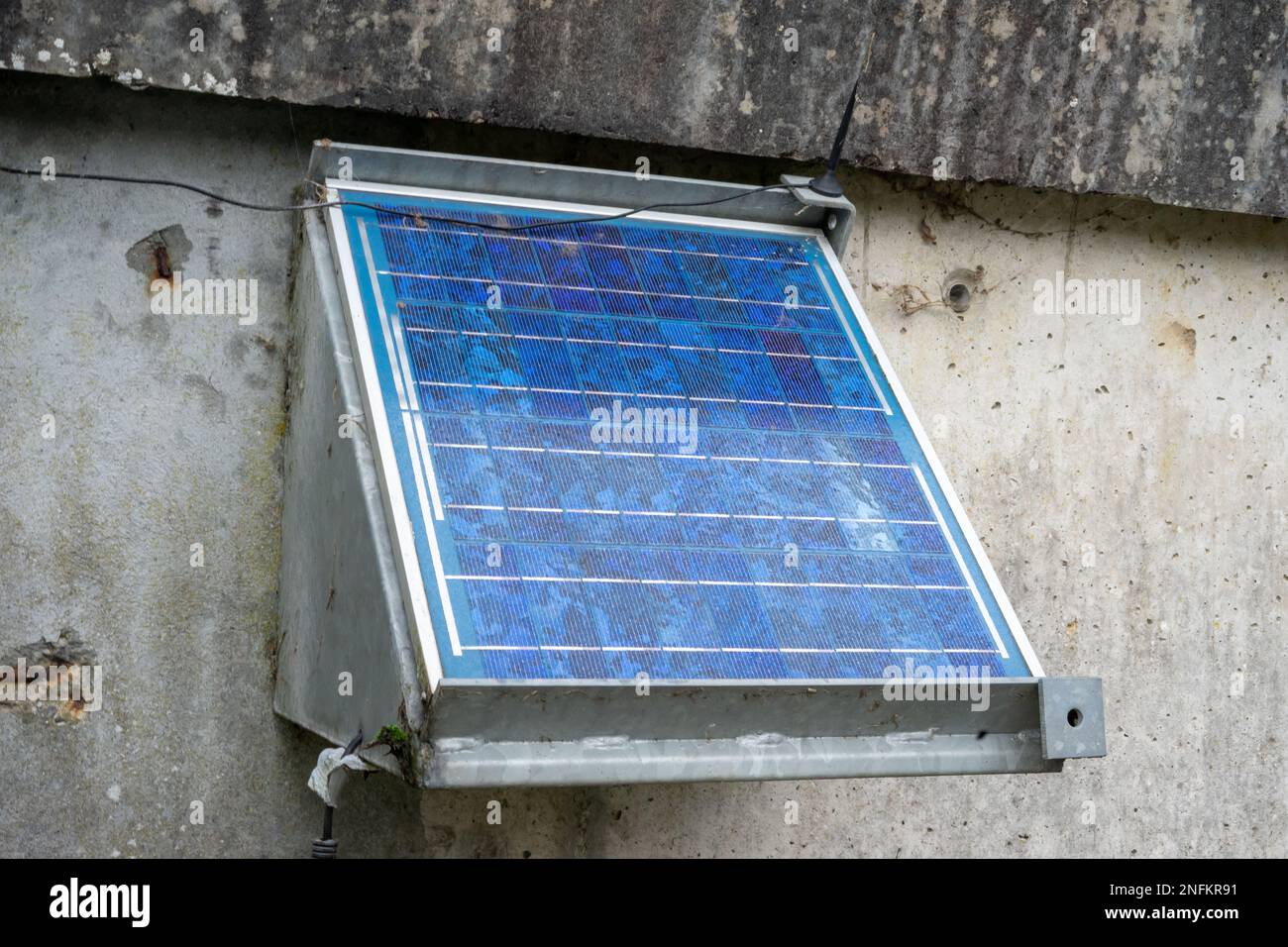 Stationary small solar panel on a concrete wall Stock Photo - Alamy